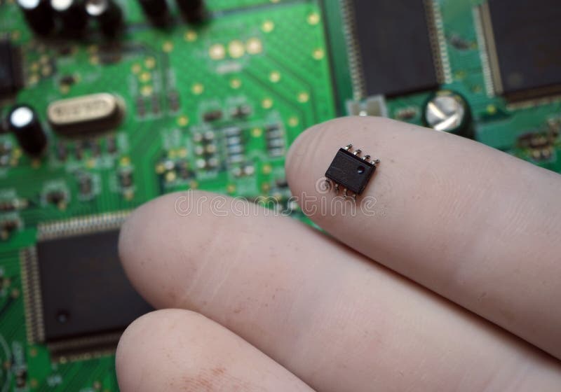 Inserting microchip stock image. Image of electronics - 273800307