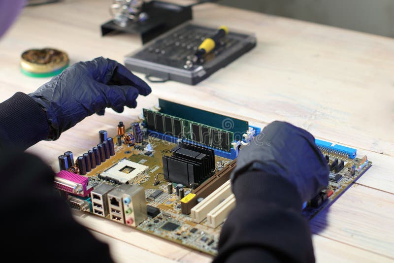 Inserting Ram into Motherboard from Computer on Table Stock Photo ...