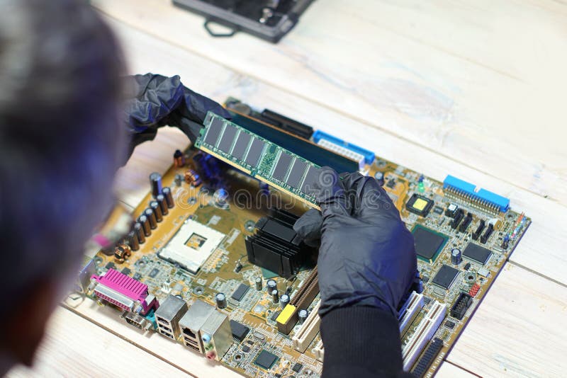 Inserting Ram into Motherboard from Computer on Table Stock Photo ...