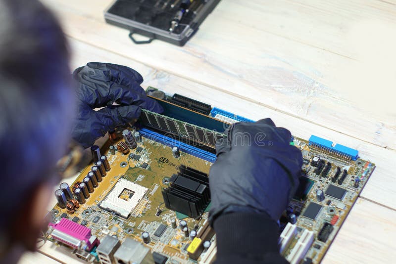 Inserting Ram into Motherboard from Computer on Table Stock Photo ...