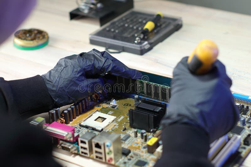 Inserting Ram into Motherboard from Computer on Table Stock Photo ...