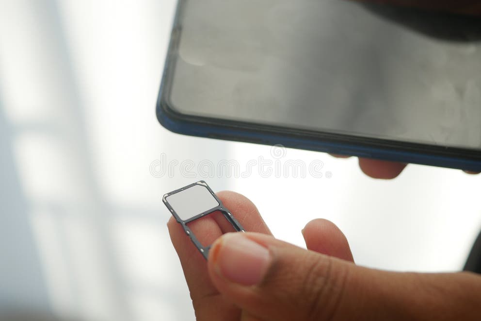 Inserting a SIM Card into a Smartphone Device for Connectivity Setup ...