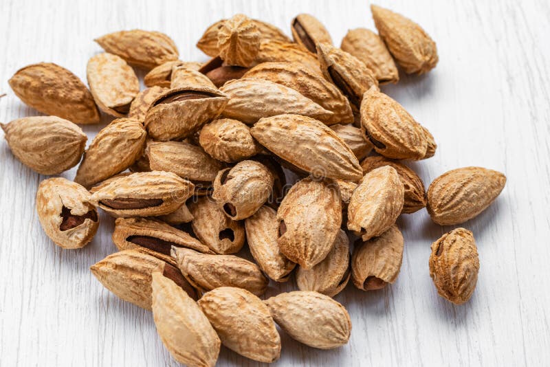 Inshell Almonds Lying in a Pile on a White Wooden Surface Stock Photo ...