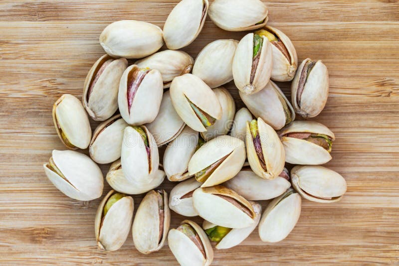 Inshell Pistachios in the Center on a Brown Wooden Surface Stock Image ...
