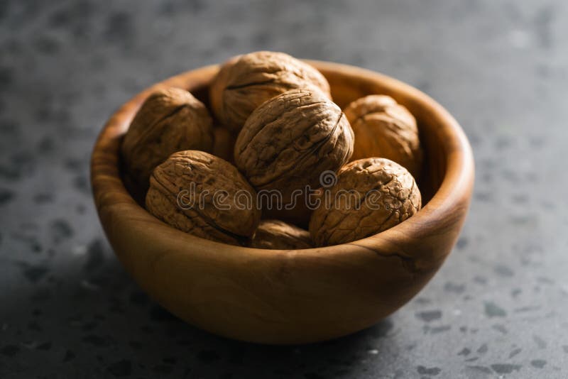 Inshell Walnuts in Olive Wood Bowl on Terrazzo Countertop Stock Photo ...