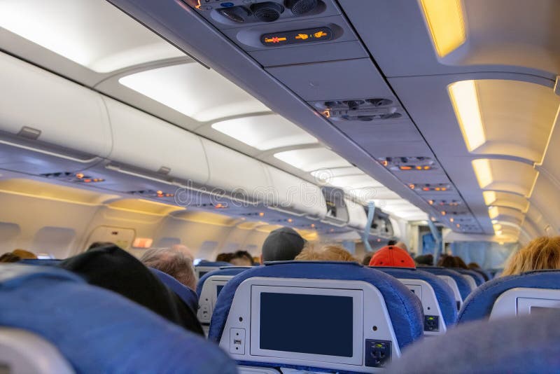 Inside of an Airplane Cabin with Passengers on Flight Stock Photo ...