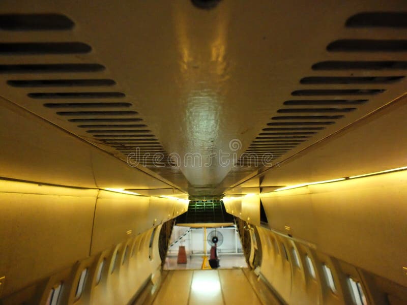 The Inside of an Airplane with a Yellow Ceiling. Stock Image - Image of ...