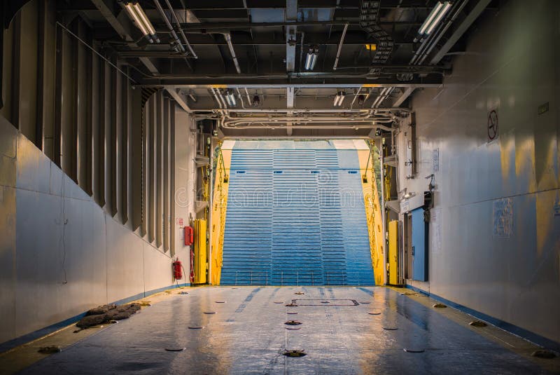 Inside Auto Deck on the Greek Ferry. Lifted Bow Ramp and the Cloudy Sky ...