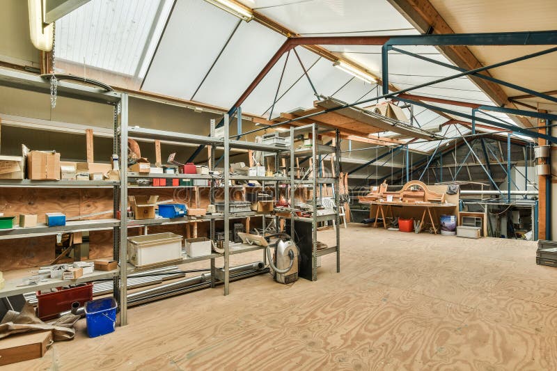 A Large Workshop with Wood Floors and Metal Shelving Stock Photo ...