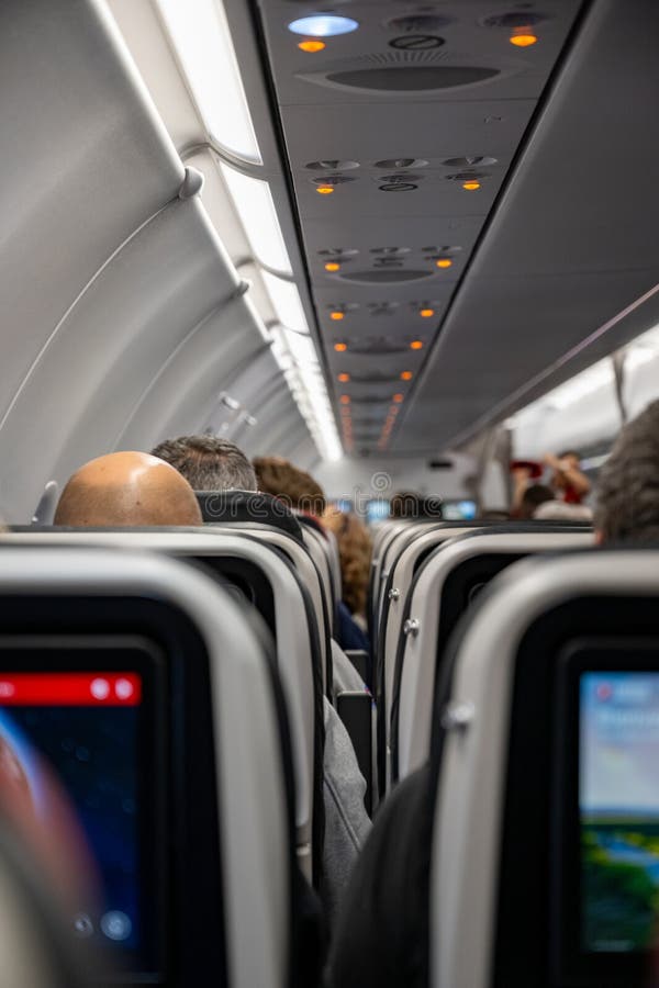 Inside the Cabin of an Airplane Looking Throught the Chairs and Some ...