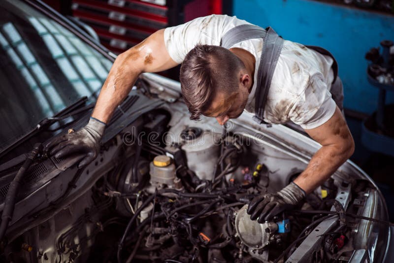 Mechanic Working on Car Engine in Auto Repair Shop Stock Photo - Image ...