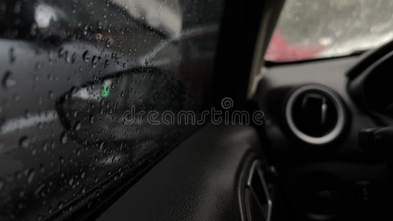 Inside a Car during Rain, Droplets Cascade Down the Window, Creating a ...
