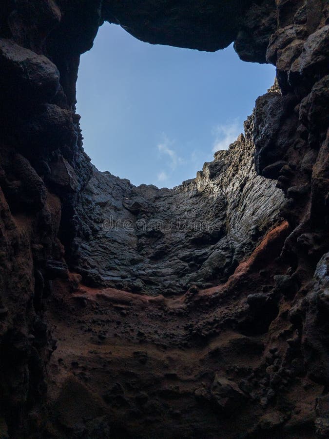 Inside of the Cave Looking Up at the Blue Sky Stock Image - Image of ...