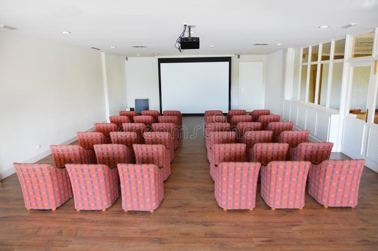 Inside of a Conference Hall with Set-up Chairs and a Screen on the Wall ...