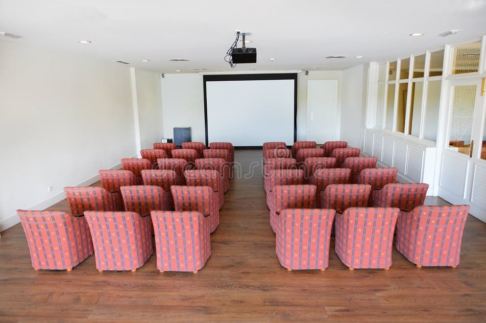 Inside of a Conference Hall with Set-up Chairs and a Screen on the Wall ...