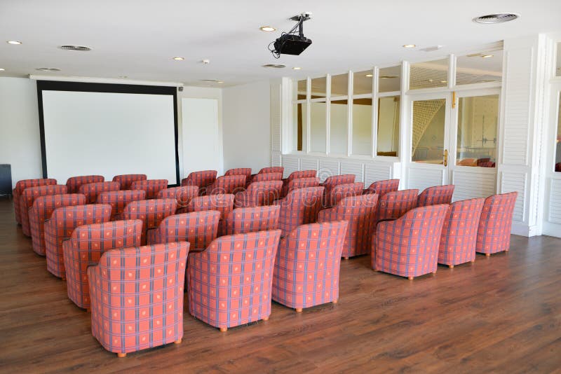 Inside of a Conference Hall with Set-up Chairs and a Screen on the Wall ...