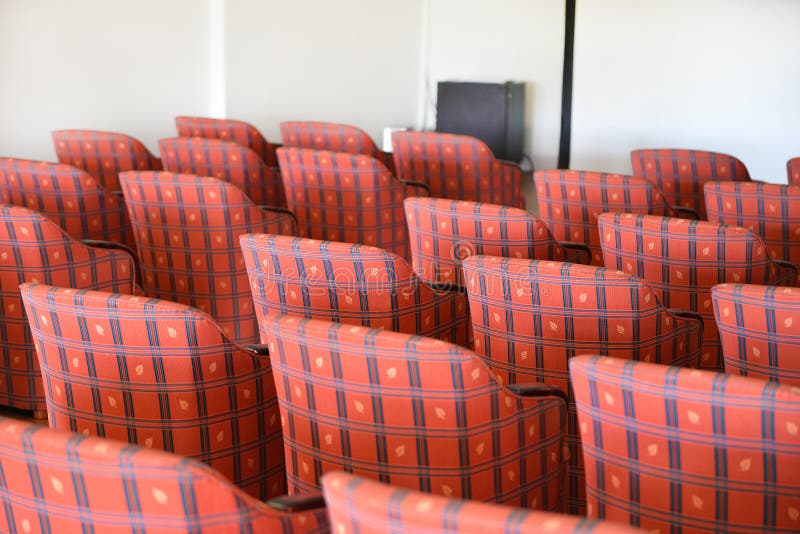 Inside of a Conference Hall with Set-up Chairs and a Screen on the Wall ...