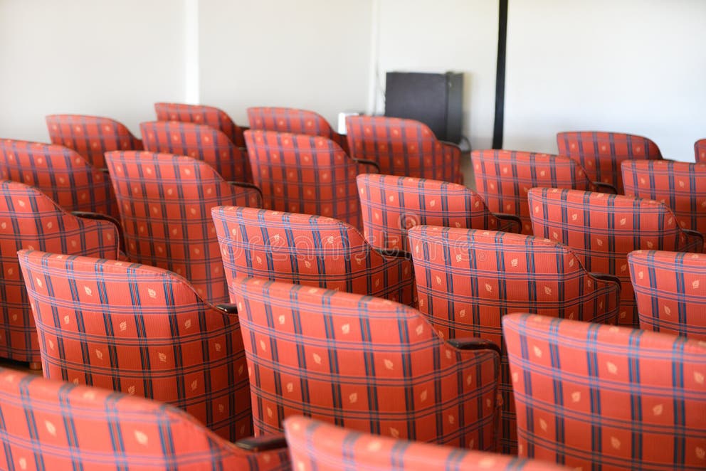 Inside of a Conference Hall with Set-up Chairs and a Screen on the Wall ...