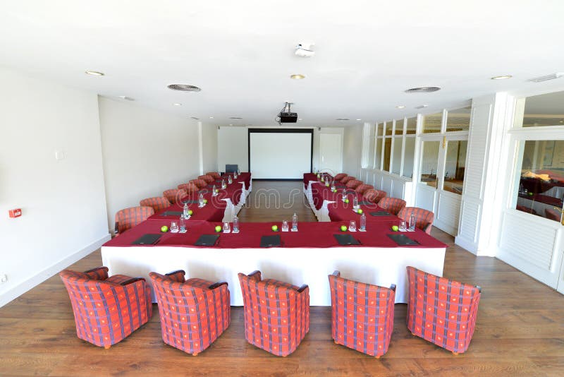 Inside of a Conference Hall with Set-up Chairs and Tables and a Screen ...