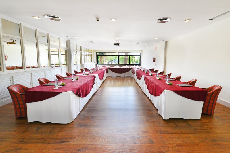 Inside of a Conference Hall with Set-up Chairs and Tables and a Screen ...