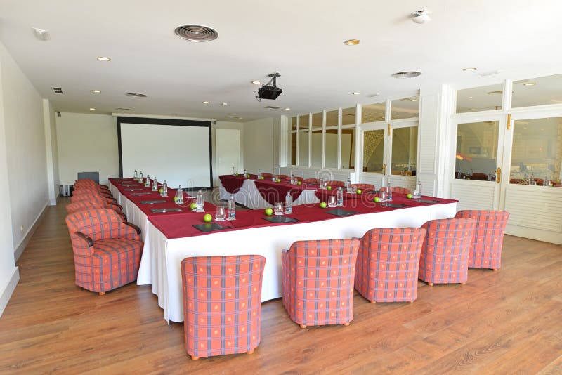 Inside of a Conference Hall with Set-up Chairs and Tables and a Screen ...