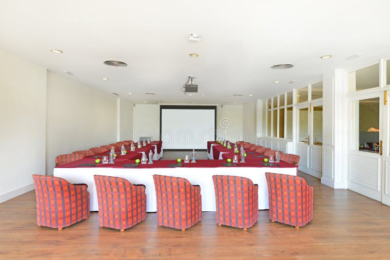 Inside of a Conference Hall with Set-up Chairs and Tables and a Screen ...