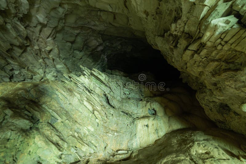Entrance To Cave in Cliff Rocks. Travel Exploration Danger Concept ...