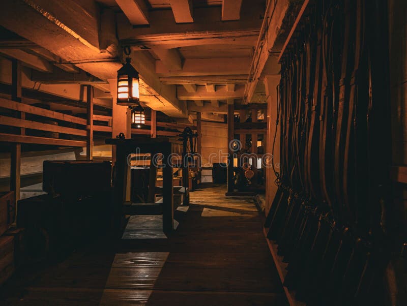 The Hull of HMS Victory. a Dim Lantern Lighting the Dark Room with a ...
