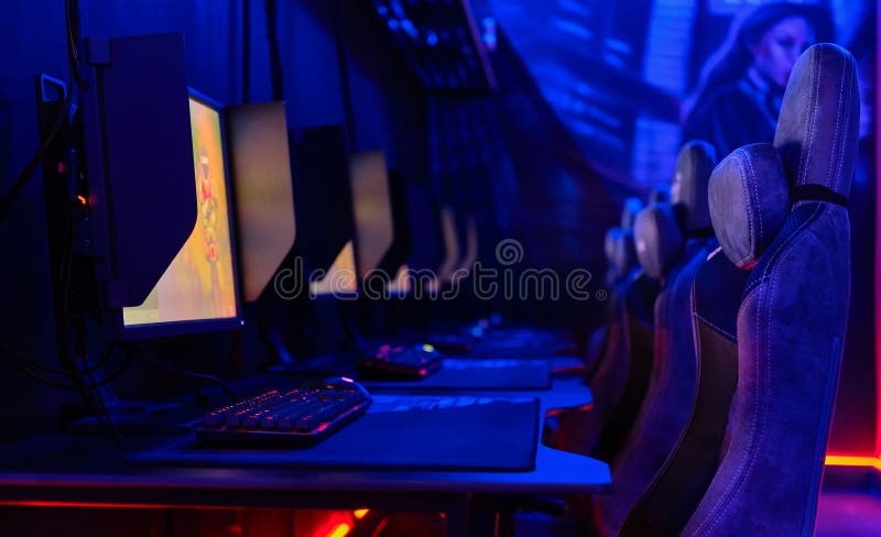 Inside of Illuminated Internet Cybercafe Tables with Computers in Row ...