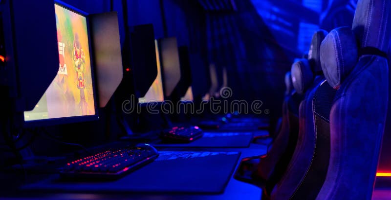 Inside of Illuminated Internet Cybercafe Tables with Computers in Row ...