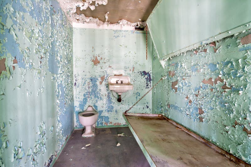 Inside a Jail Cell with a Metal Bed Stock Photo - Image of weathered ...