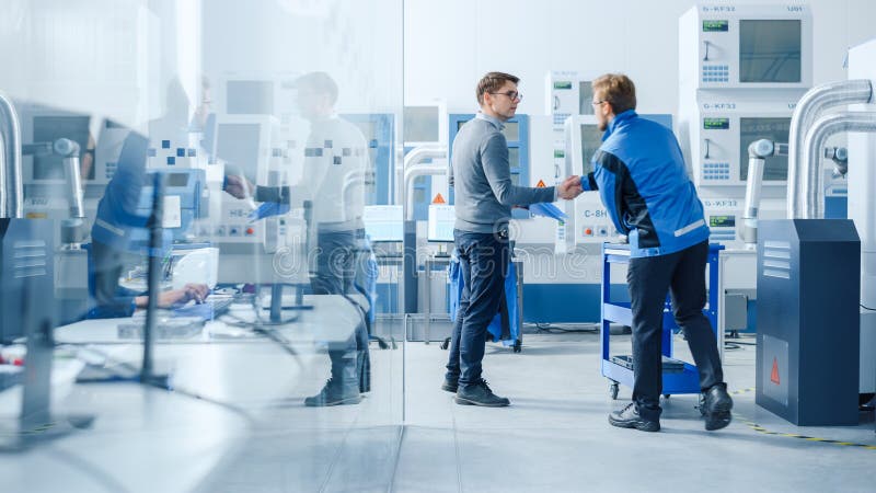 Inside Factory Glass Office Team of Industrial Engineers Working on PC ...