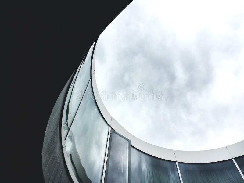 The Inside of a Round Building in a Glass Facade with a Cloudy Sky in ...