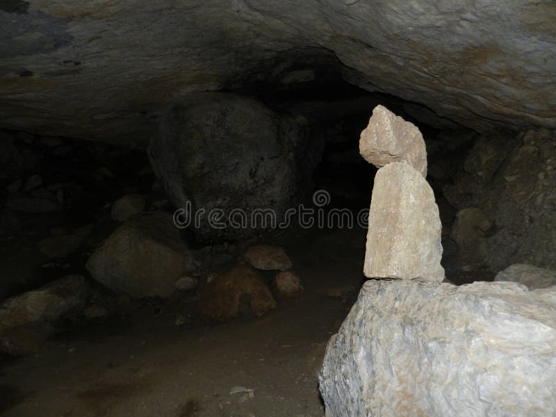 Inside a Small Cave with a Balanced Stone Tower Stock Image - Image of ...
