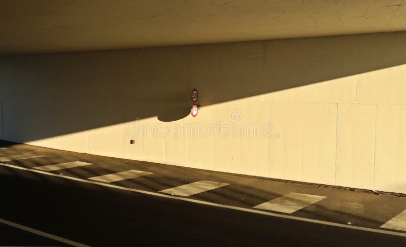 Inside of an Underpass with Concrete Wall with Two Road Sign, Divided ...