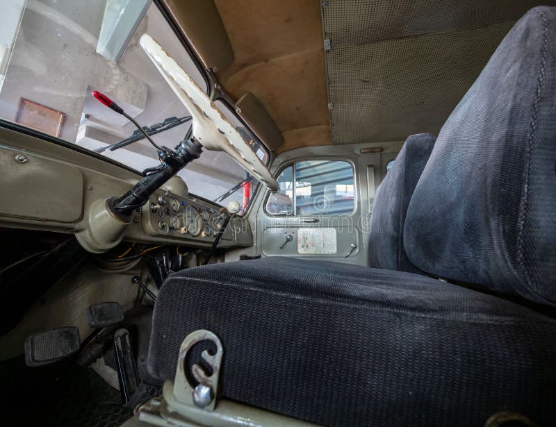 Inside View of an Old Fire Truck with Black Seats and a White Steering ...