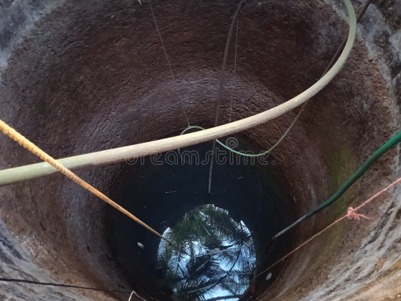 Inside View of Old Water Well and Reflection of Sky on the Surface of ...