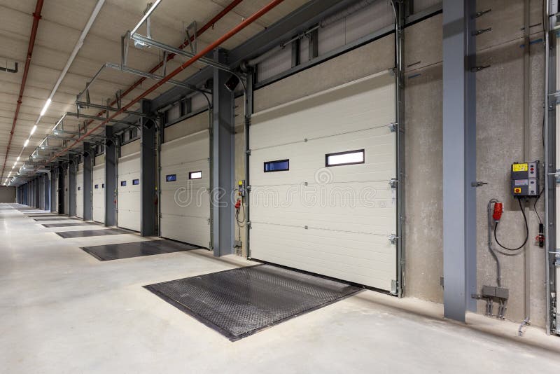 Inside of a Warehouse with a Row of Loading Bays Stock Photo - Image of ...