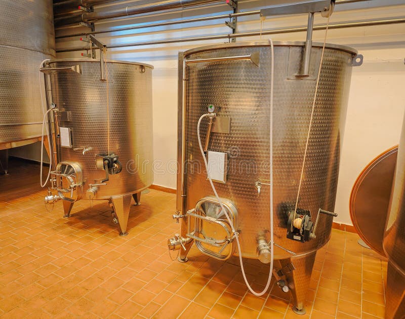 Inside a Winery. Wine Cellar with with Steel Barrels for Fermentation ...