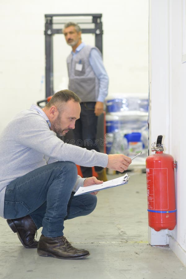 Inspecting the Fire Extinguisher Stock Image - Image of function ...