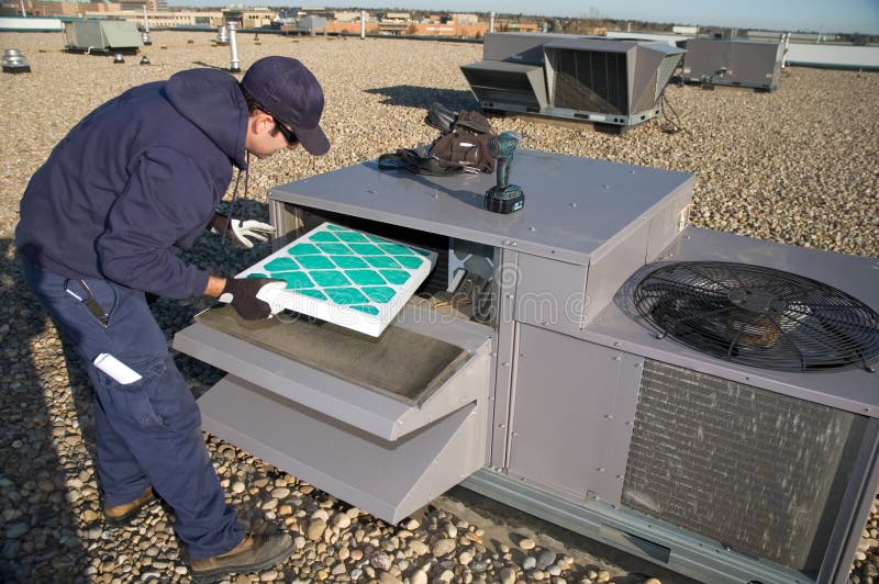 Inspecting roof top unit stock image. Image of young - 12055205