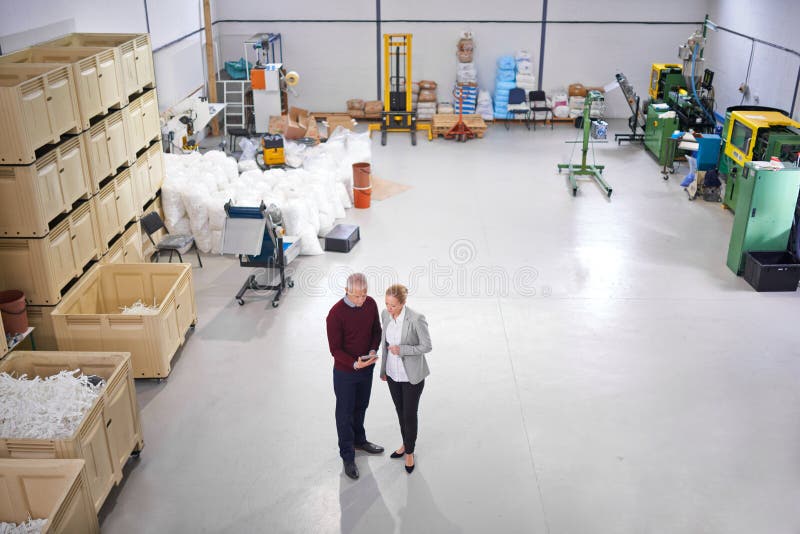 Inspection in Progress. High Angle Shot of Two Factory Managers Using a ...