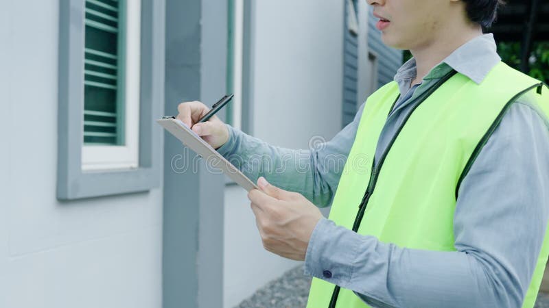 Inspector or Engineer is Inspecting and Inspecting a Building or House ...