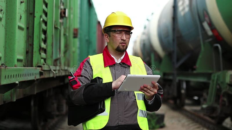 Railway Worker with Tablet Pc Near Freight Trains Stock Video - Video ...
