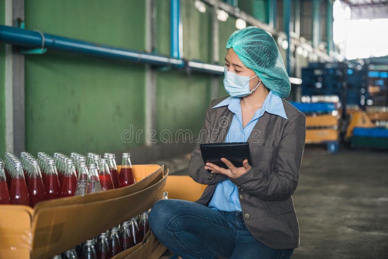 Inspector and Supervisor Asian Woman Checking with Tablet a Bottled ...