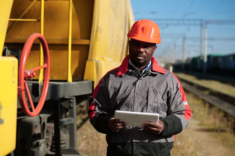 Inspector of Wagons at Freight Train Station with Tablet Computer Stock ...