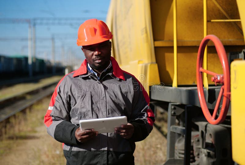 Inspector of Wagons at Freight Train Station with Tablet Computer Stock ...