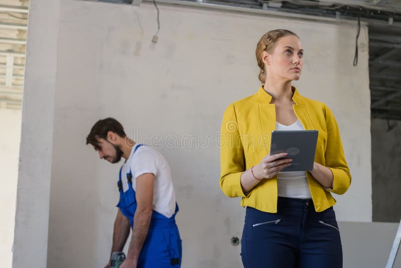 A Inspector Watching Builders and Writing Notes Stock Photo - Image of ...