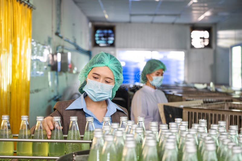Inspector Woman Checking a Bottled Fruit Beverage on Conveyer ...