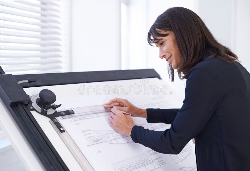An Inspired Architect. a Female Architect Working on a Building Plan at ...